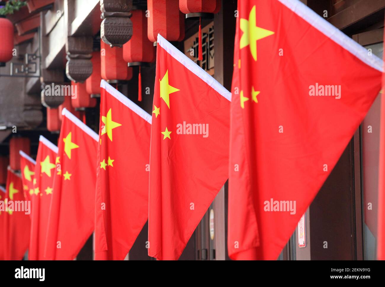 A line of Chinese national flags fly on the street prior to the ...