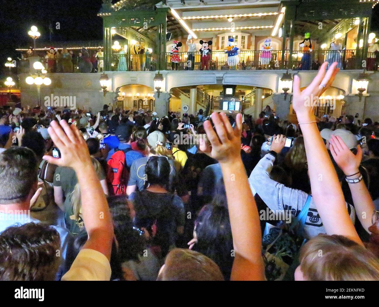Guests wave goodbye to Mickey Mouse and friends on Main Street USA, in ...