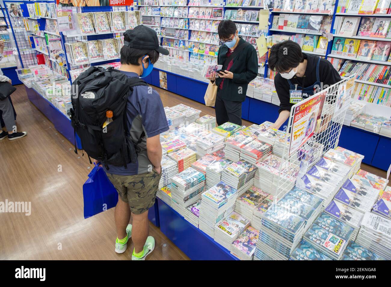 Employee and customers inside a manga bookstore in Ikebukuro. Manga ...