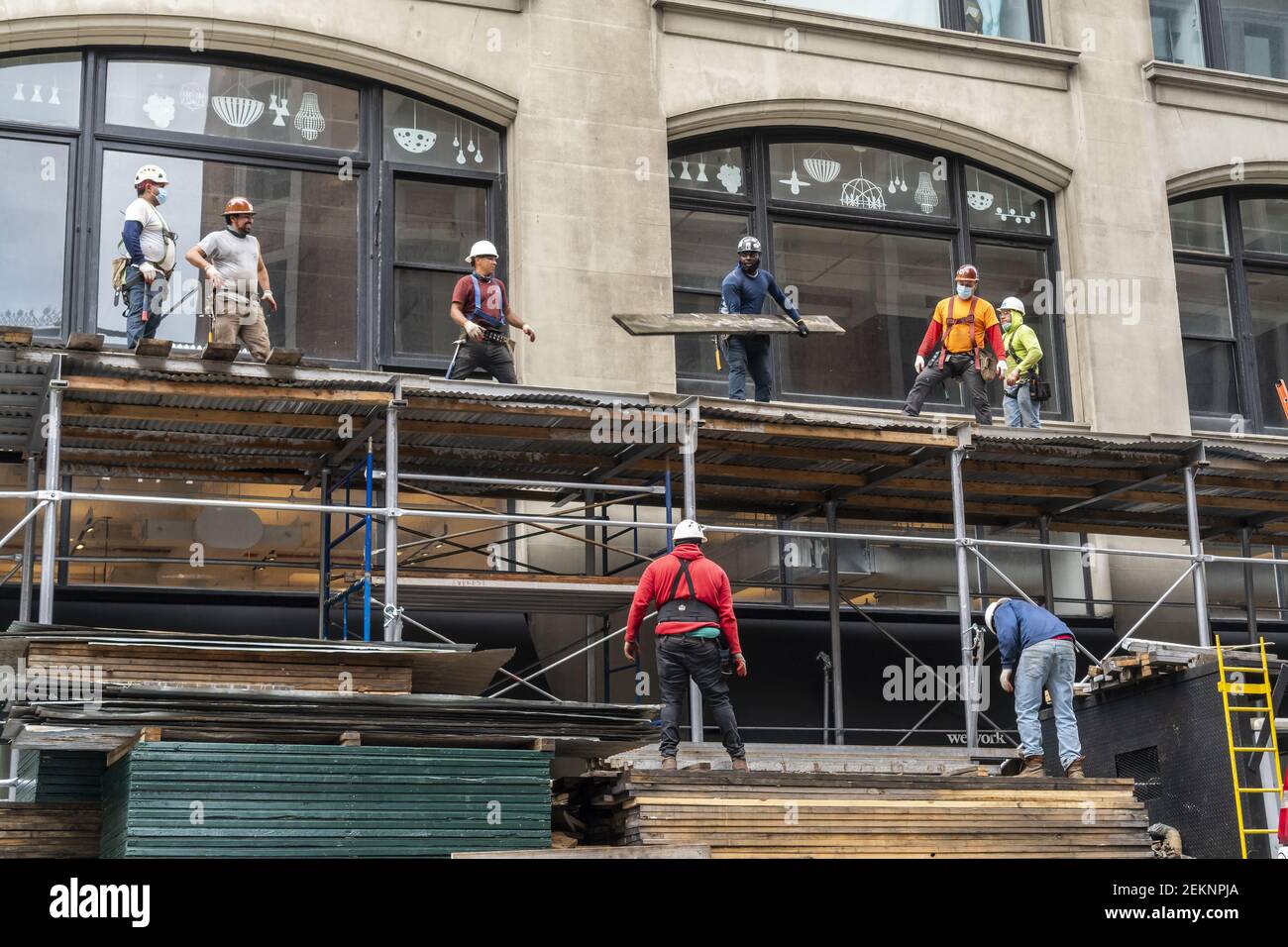 Workers form a human chain to construct scaffolding in the Flatiron ...