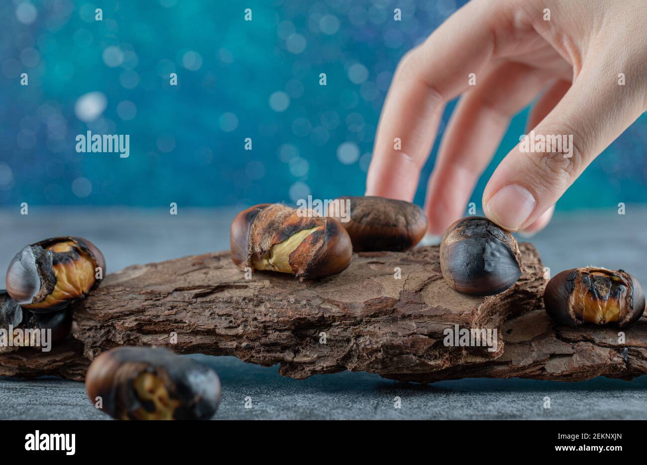 Delicious fried chestnuts on a tree bark Stock Photo - Alamy
