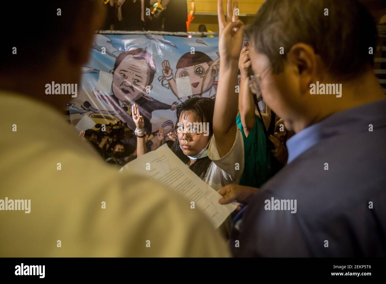 An female high school student protester seen raising her hands showing ...