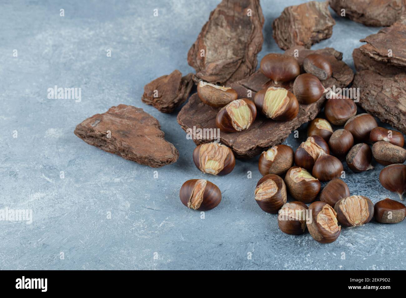 Delicious healthy chestnuts on a tree bark Stock Photo - Alamy