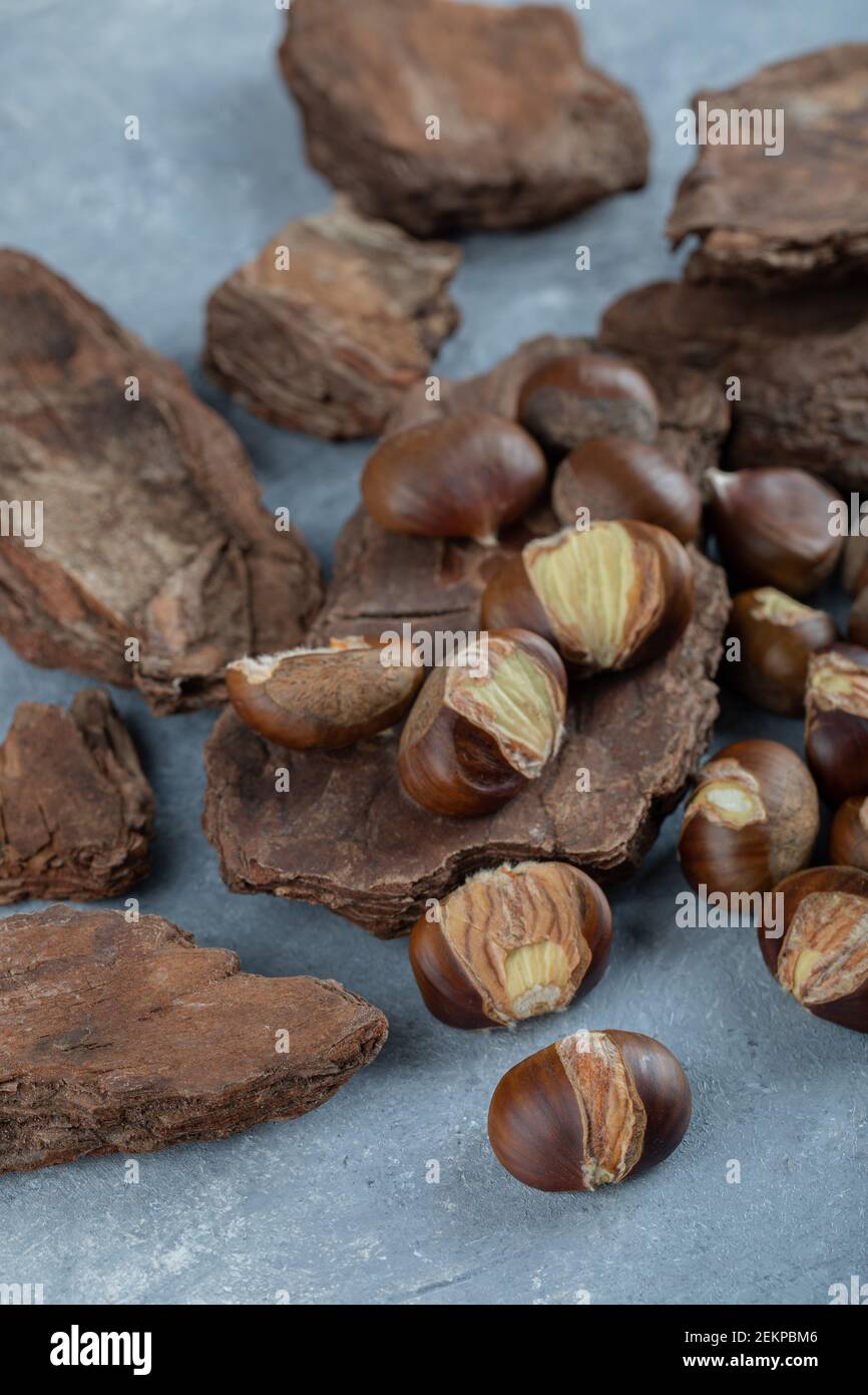 Roasted chestnuts on marble background with wood pieces Stock Photo - Alamy