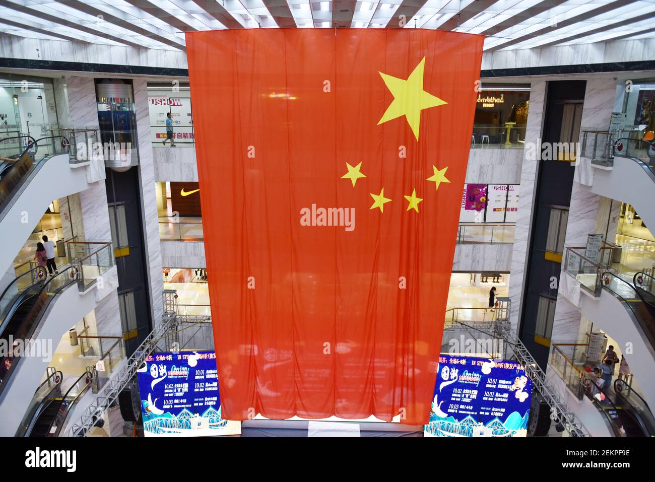 A huge Chinese flag is seen flying at Yi Xin Cheng shopping mall ...