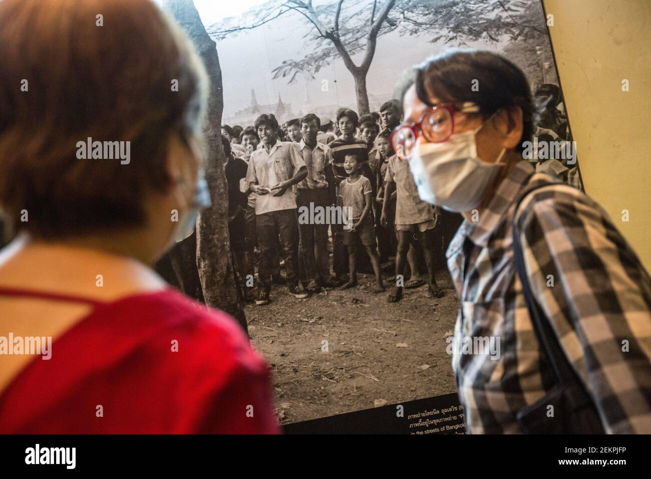 Visitors look at a photograph from US photojournalist Neal Ulevich of a ...
