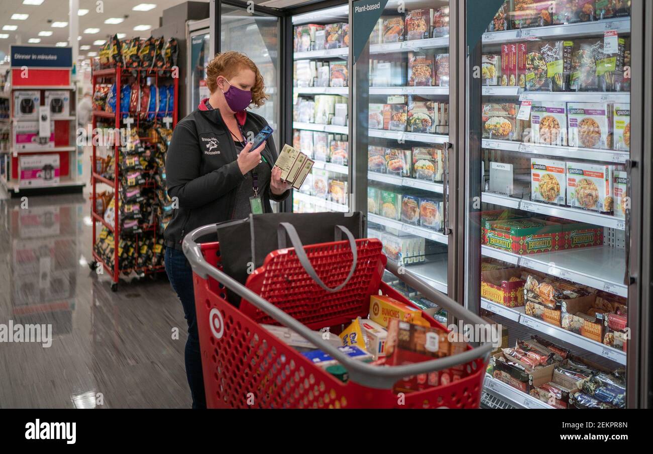 A worker shops the Target Midway store for a Shipt client on September ...