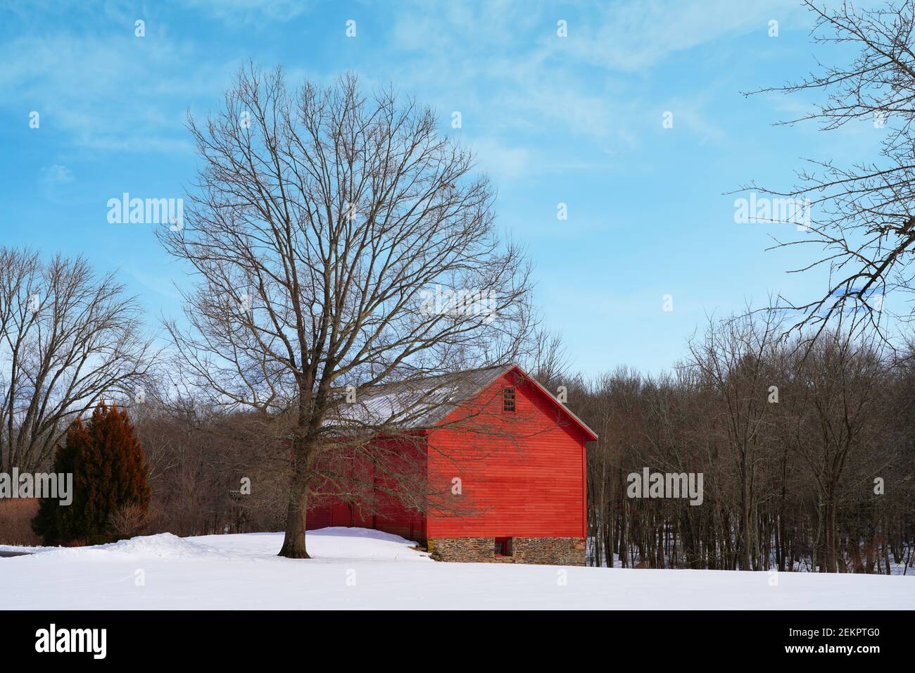View of a traditional red barn under snow after a winter storm in New ...