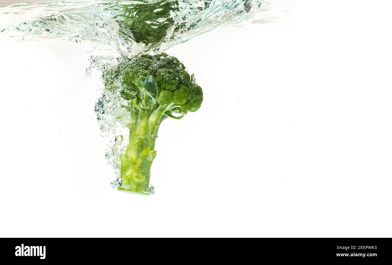 Close-up of broccoli splash into water isolated on white. Healthy food ...