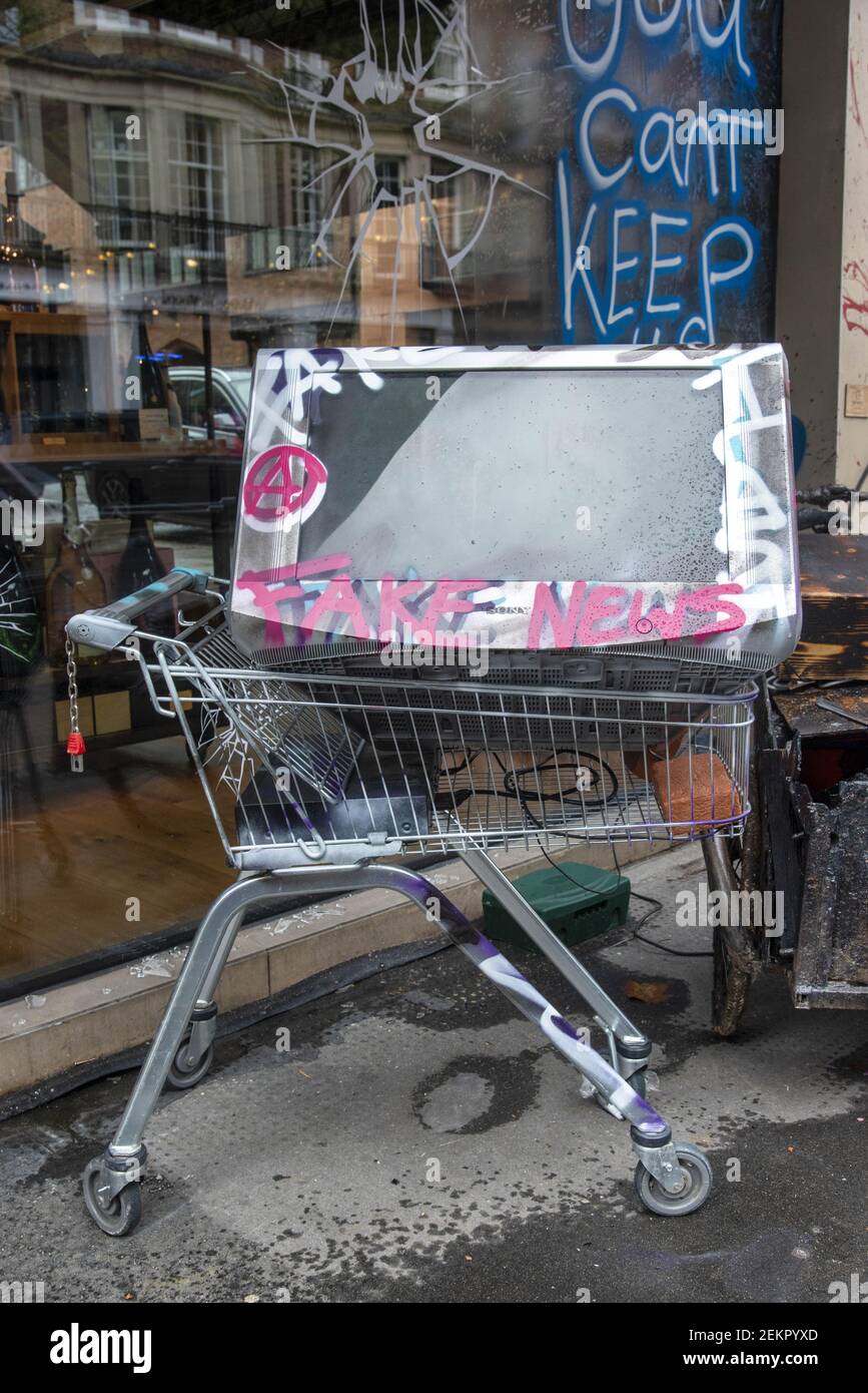 A television at a shopping trolley with the words ‘Fake News’ sprayed ...