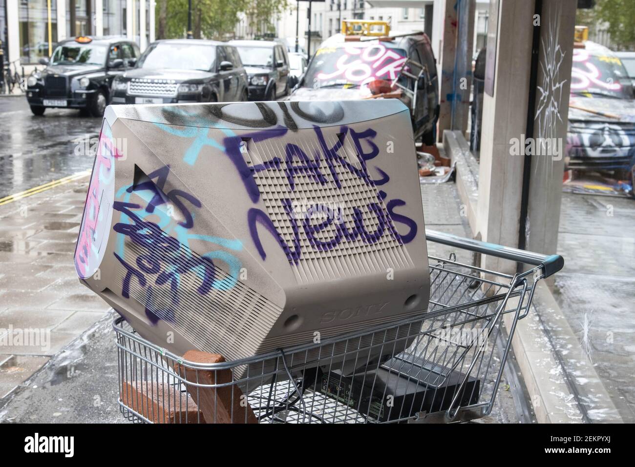 A television at a shopping trolley with the words ‘Fake News’ sprayed ...