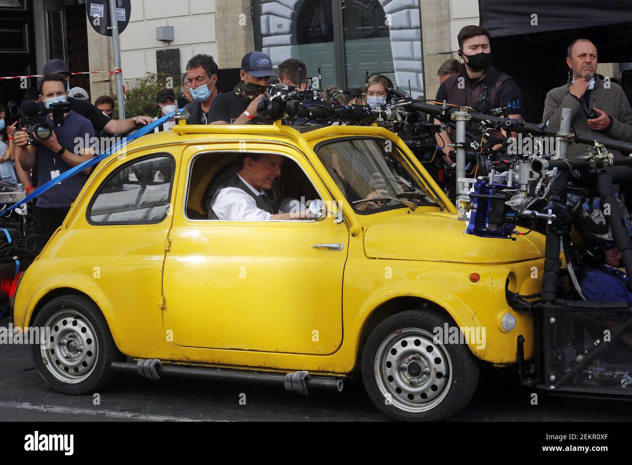 Actor Tom Cruise and actress Hayley Atwell in a yellow Fiat 500 on the ...