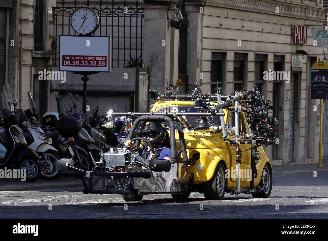 Actor Tom Cruise and actress Hayley Atwell in a yellow Fiat 500 driven ...