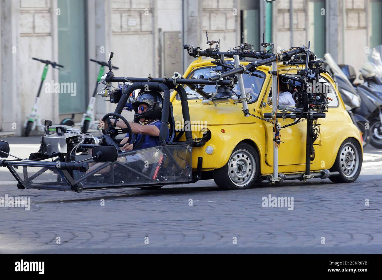 Actor Tom Cruise and actress Hayley Atwell in a yellow Fiat 500 driven ...