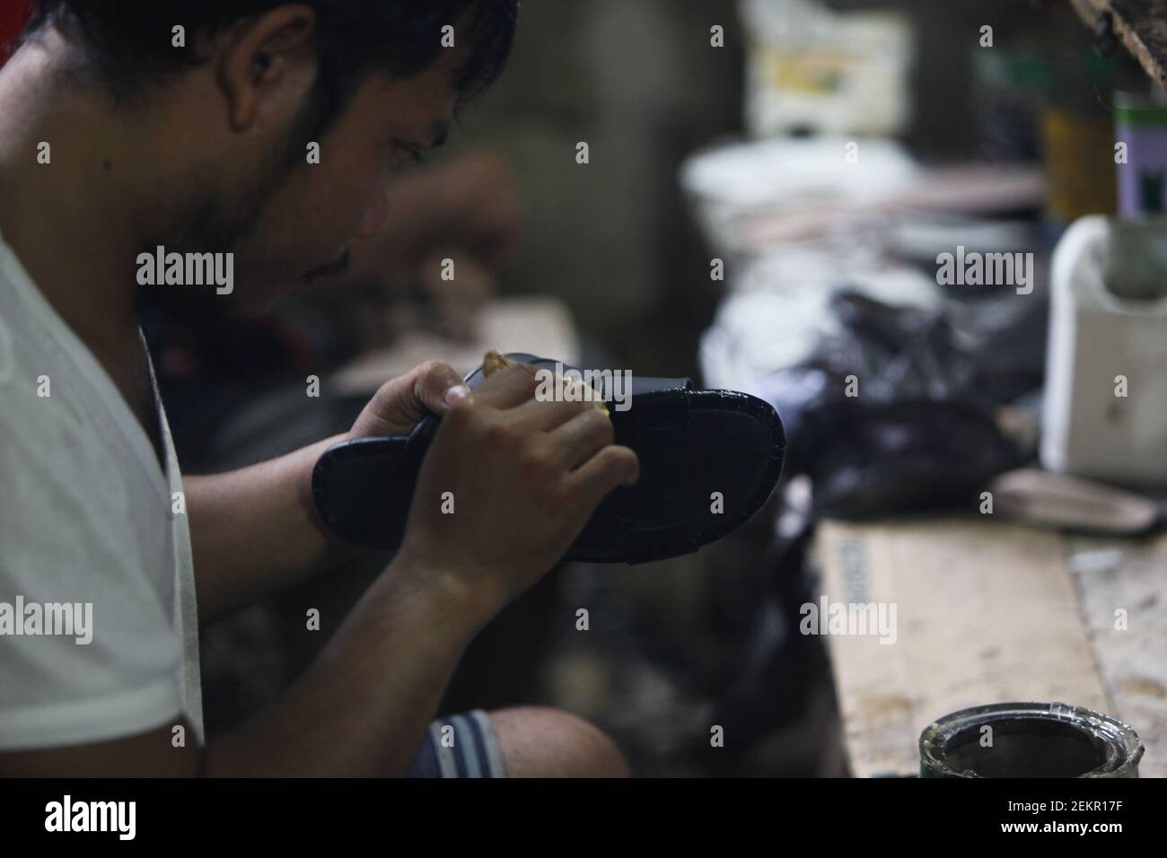 An employee works on shoes at a home Belinda shoes factory in Ciomas ...