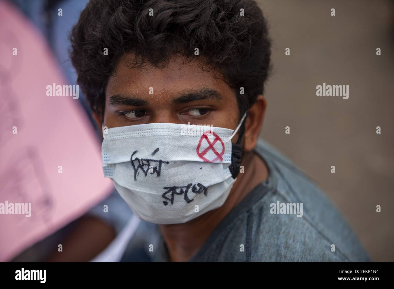 A protester wearing a face mask with inscriptions expressing his ...