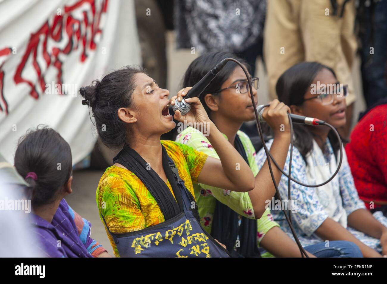 A protester shouting slogans over the microphone during the ...