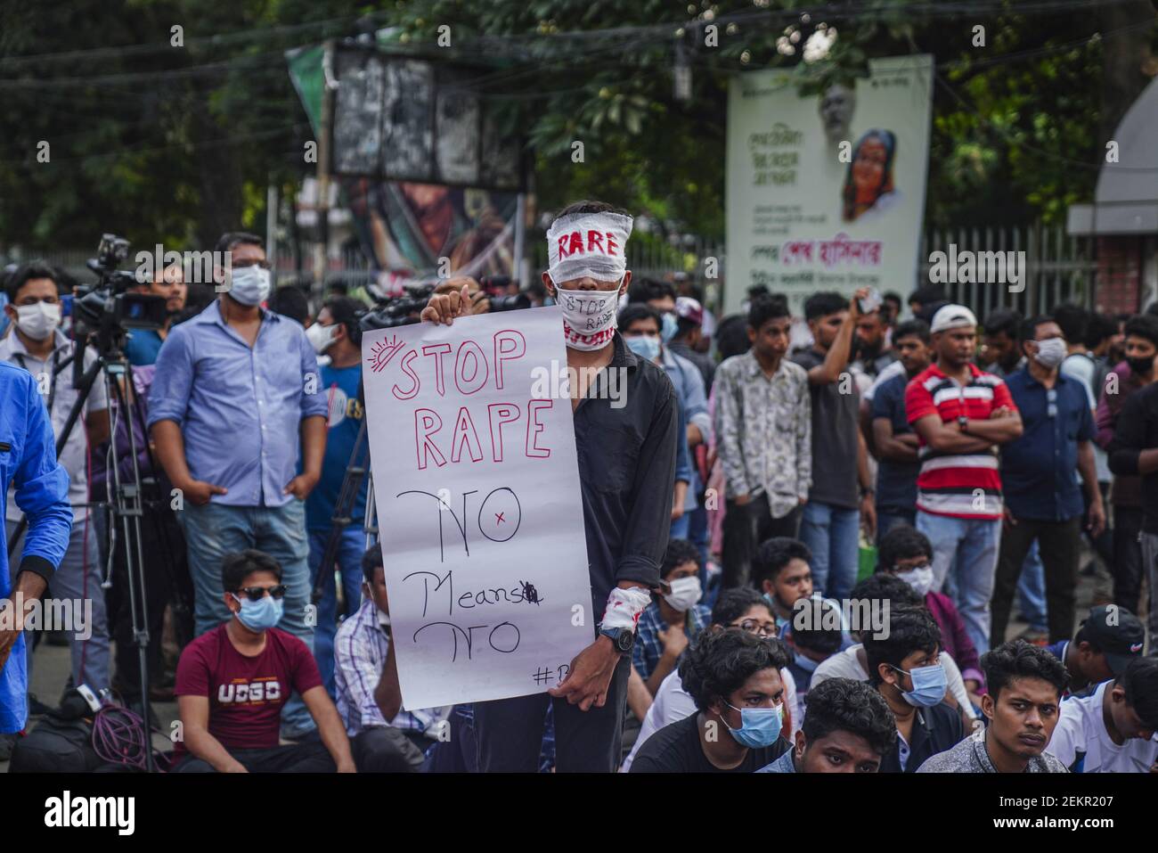 A masked student holds a placard during the demonstration. Students and ...