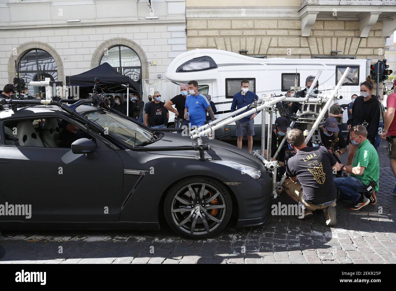 The coupe trying to fix a camera after a car crash occurred on the set ...