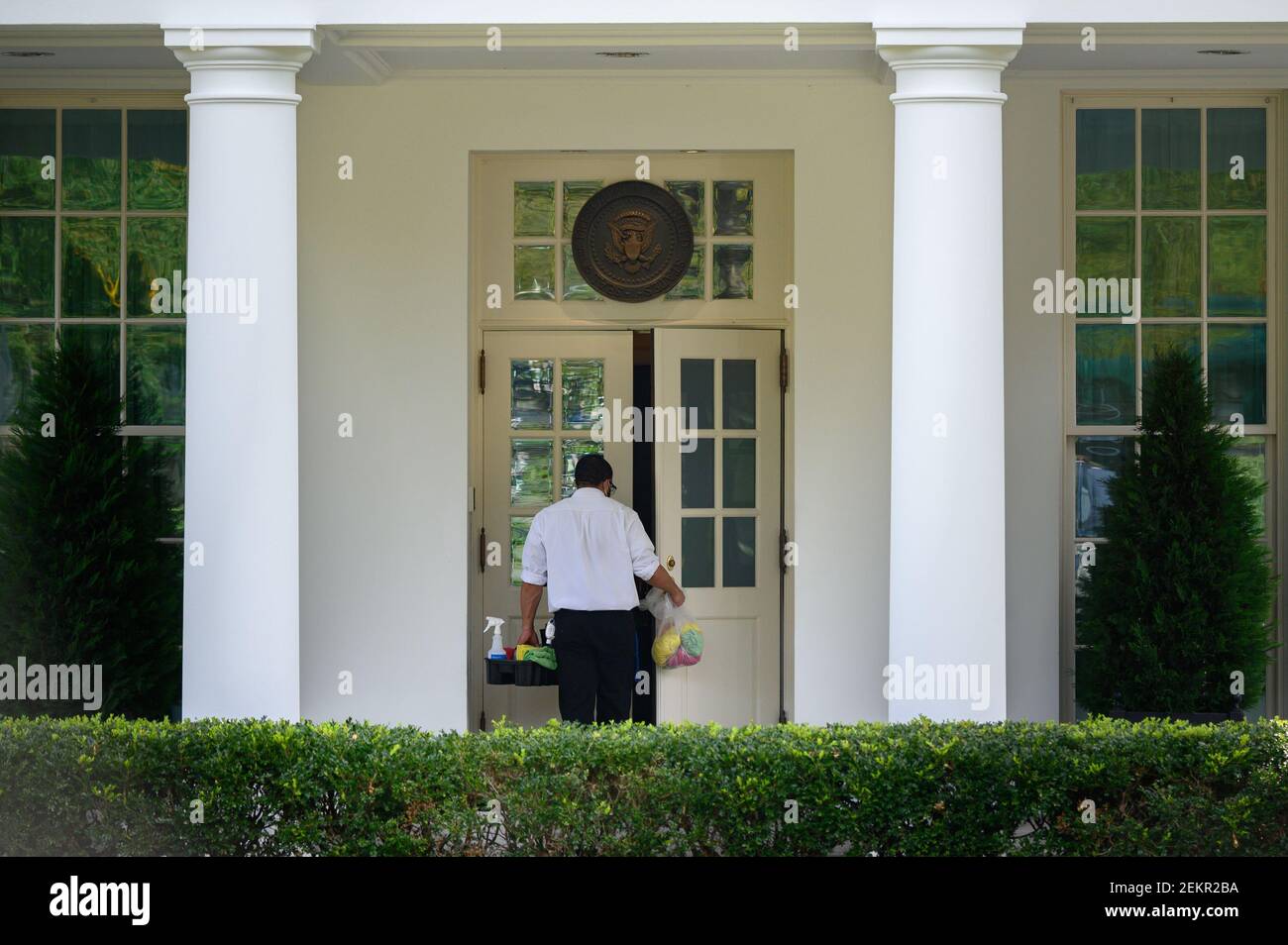 A member of the White House cleaning staff enters the West Wing of the ...