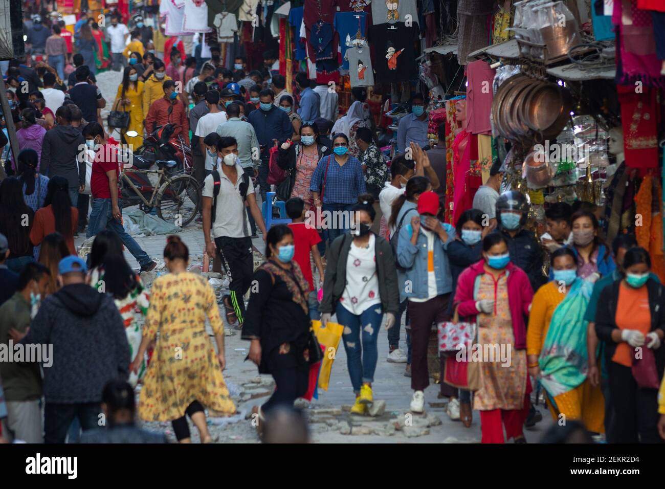 People wearing face mask as a preventive measure walk around the market amid the spread of ...