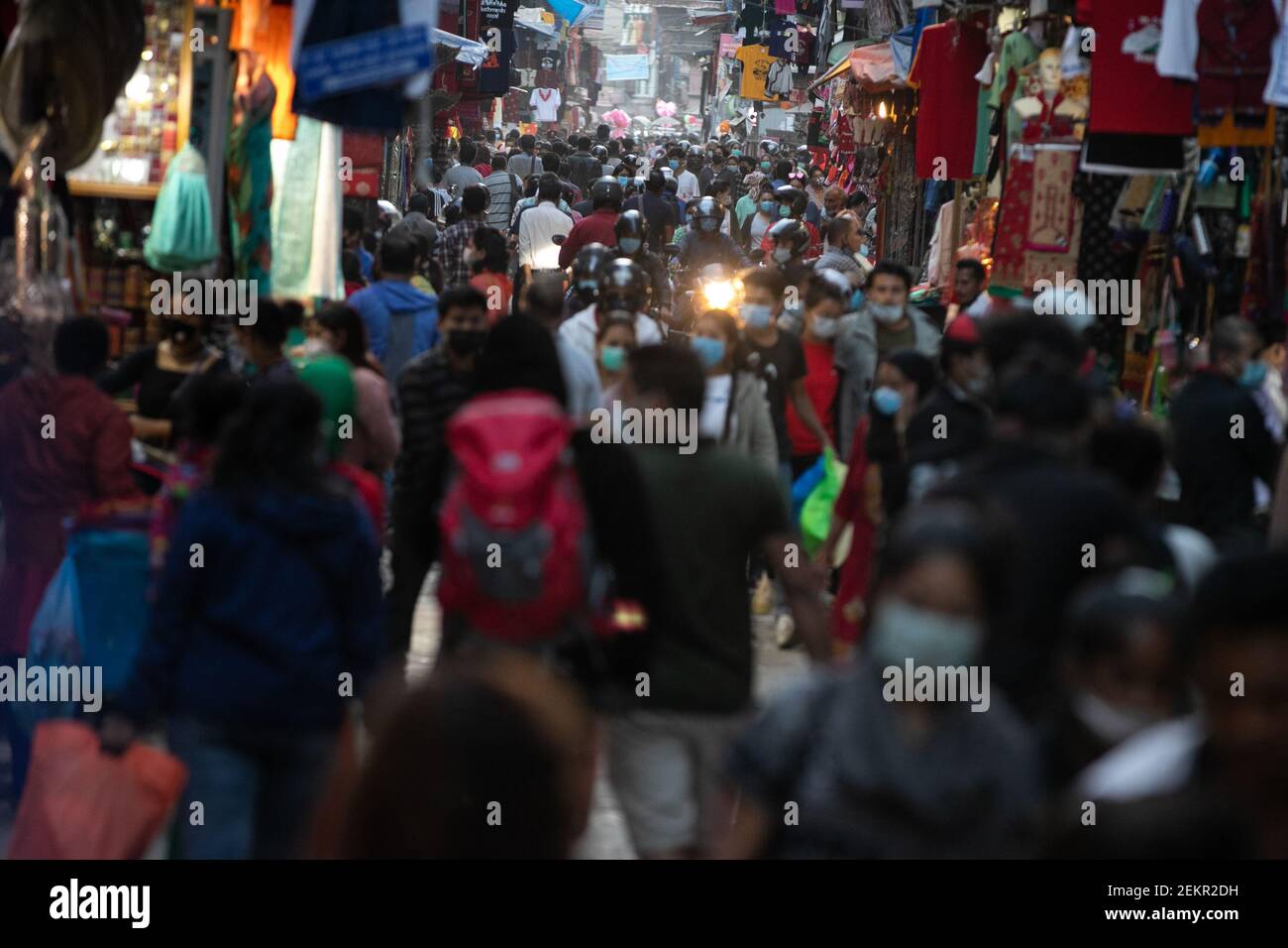 People wearing face mask as a preventive measure walk around the market amid the spread of ...