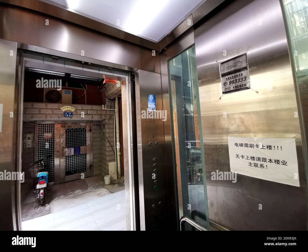 An elevator is built on the outside of an old apartment building to ...