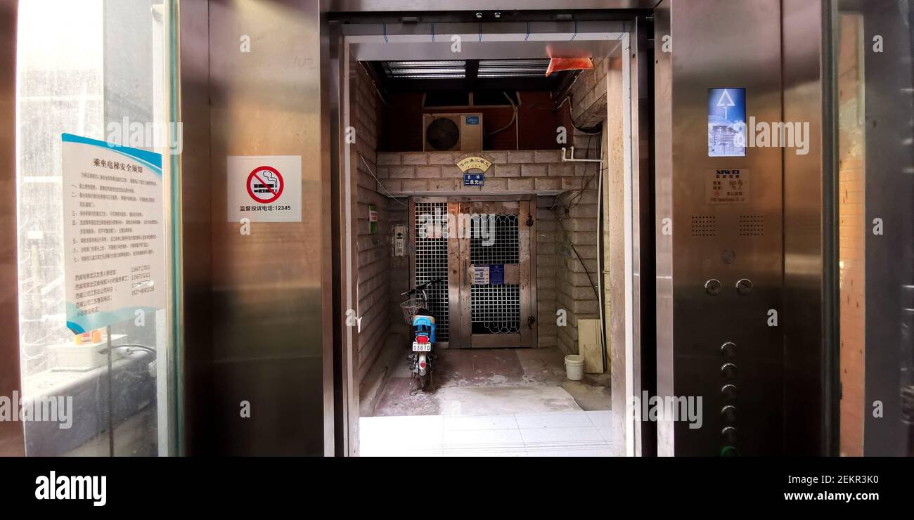 An elevator is built on the outside of an old apartment building to ...