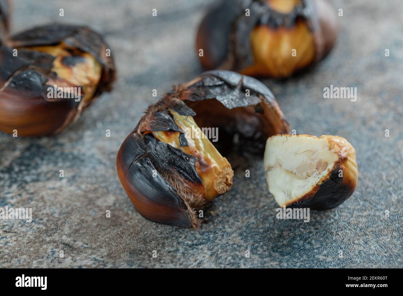Delicious fried chestnuts on a gray background Stock Photo - Alamy