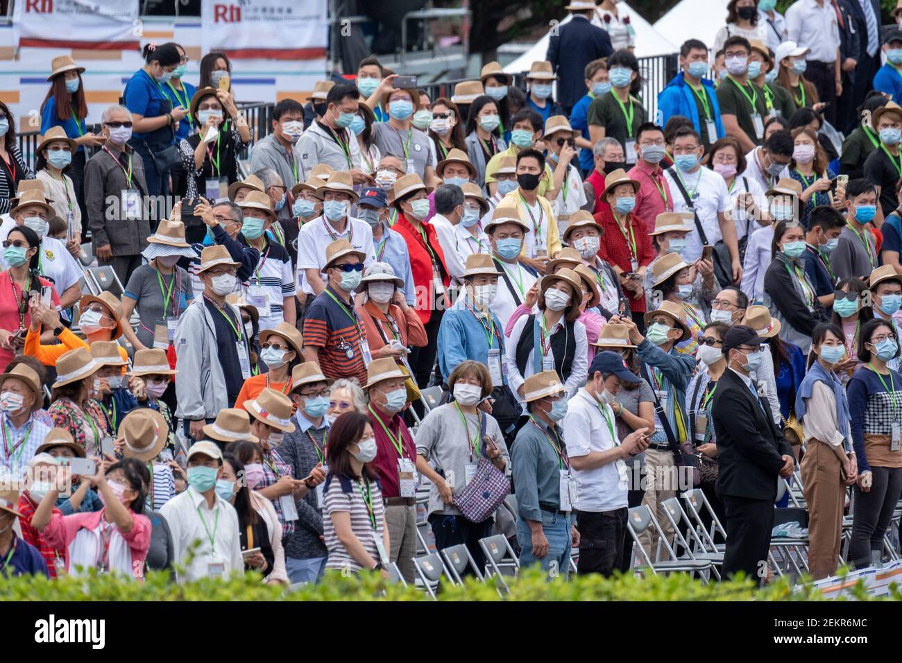 A large crowd of people wearing face masks are seen watching the show ...