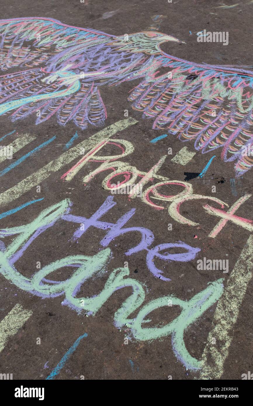 View of a chalk message and drawing on the ground during the ...