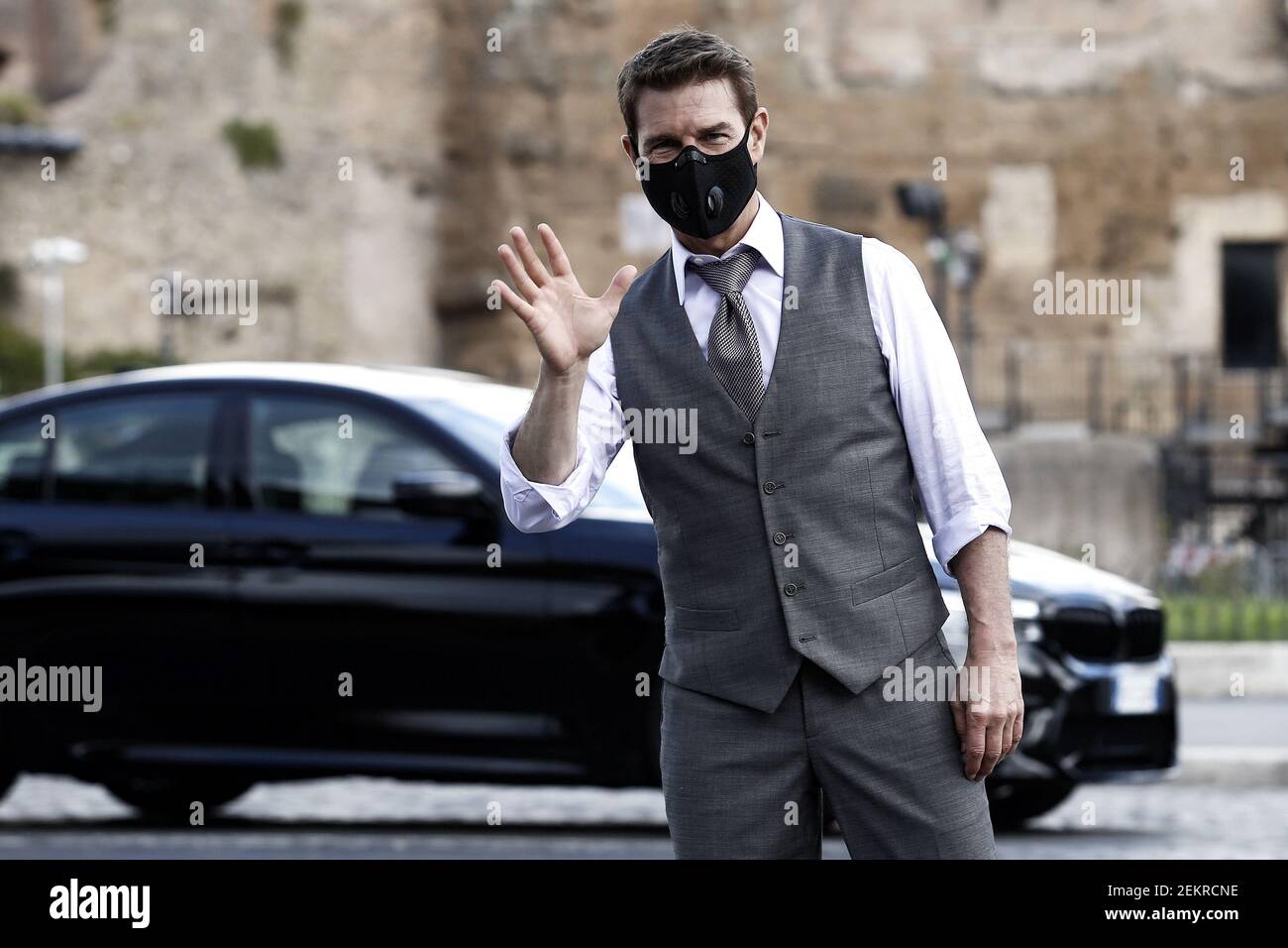 Actor Tom Cruise wearing a face mask waves at his fans on the set of ...
