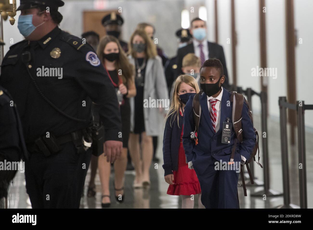 The children of Judge Amy Coney Barrett are escorted for their exit ...