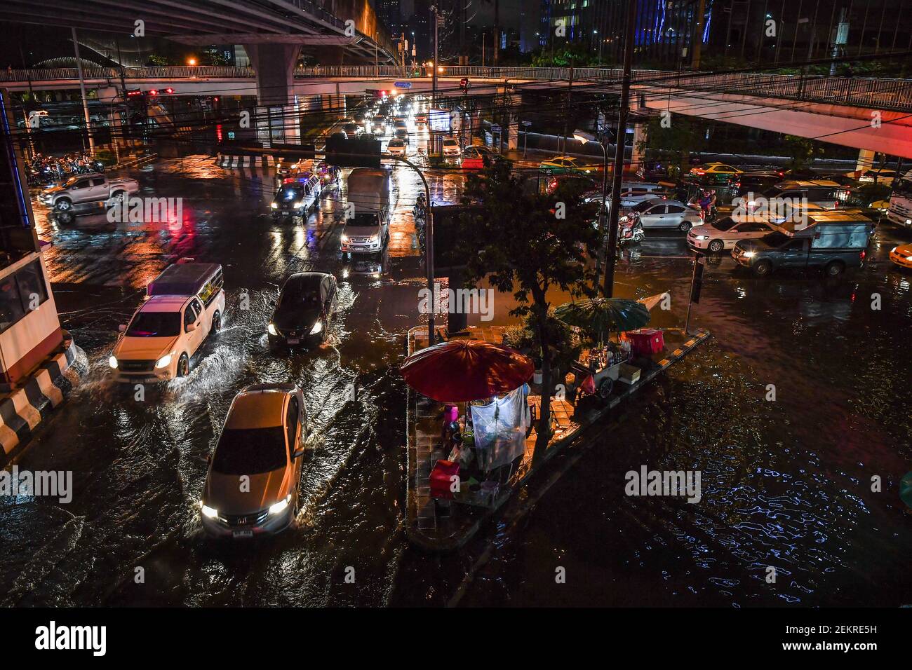 A vehicle seen splashing water as it moves on a waterlogged street ...