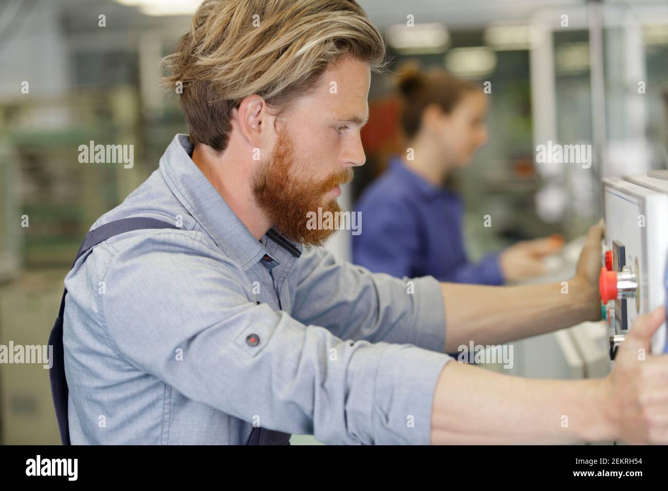 engineer looking at an industrial control panel Stock Photo - Alamy