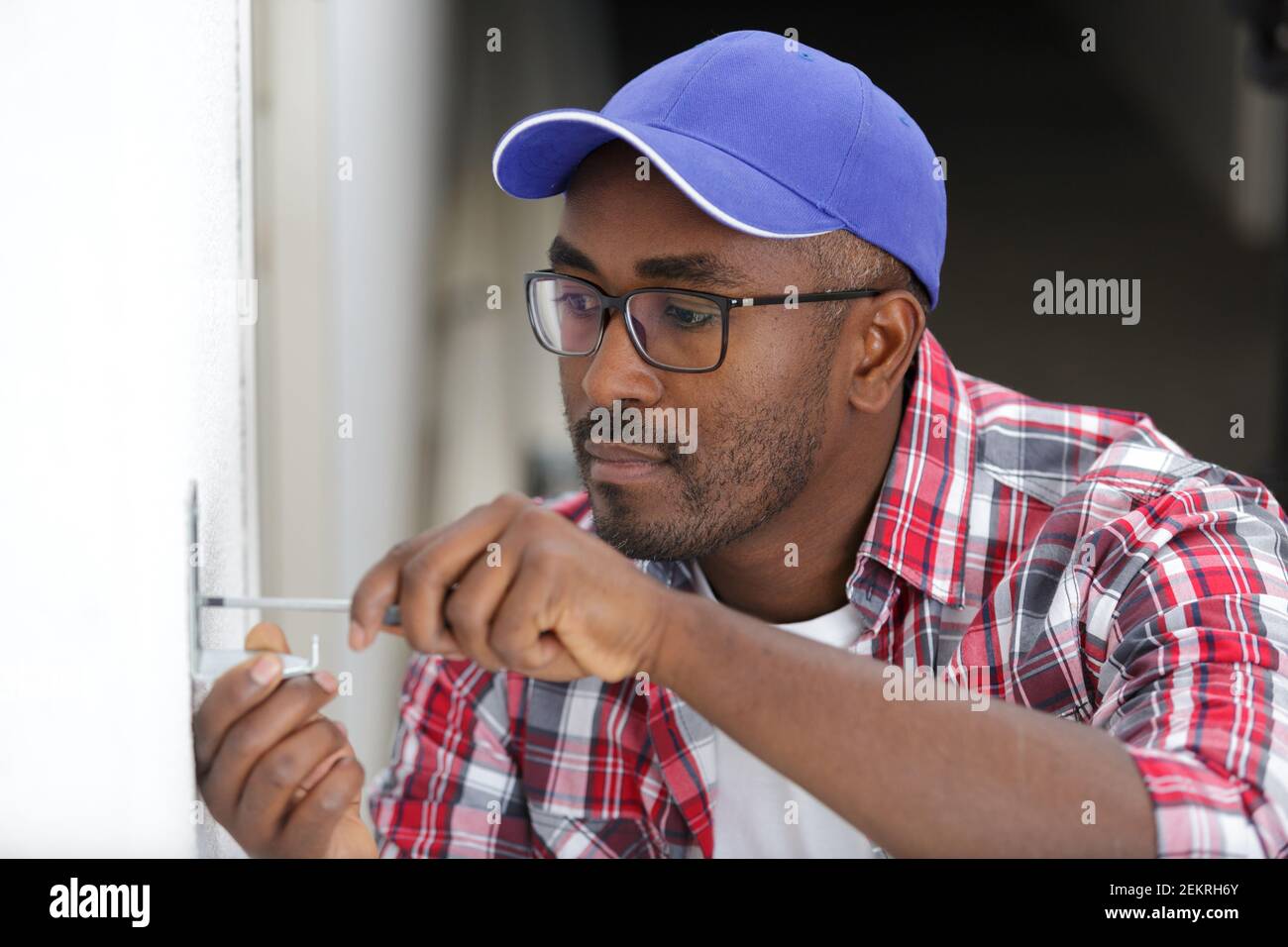 close-up of a male repairman fixing window with screwdriver Stock Photo ...