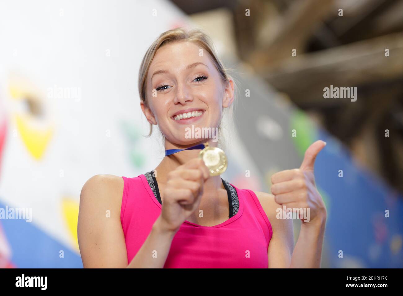 winner hand raised and holding a gold medal Stock Photo - Alamy
