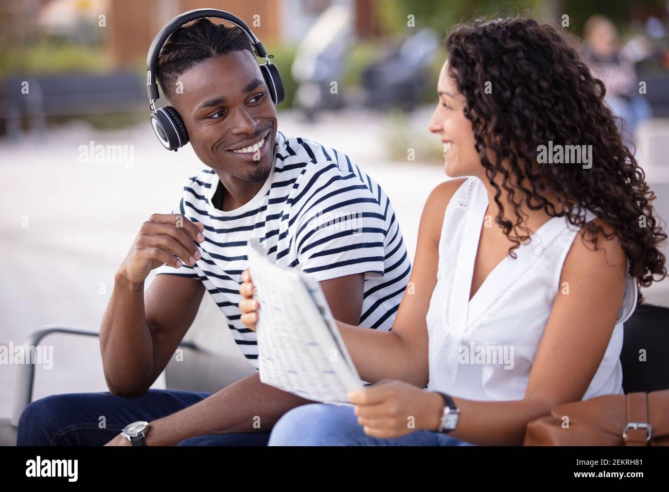 positive relaxed couple traveler on bench Stock Photo - Alamy