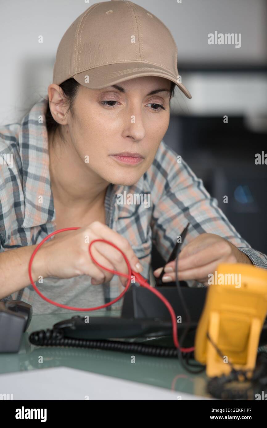 female electrician measures the voltage of a device Stock Photo - Alamy