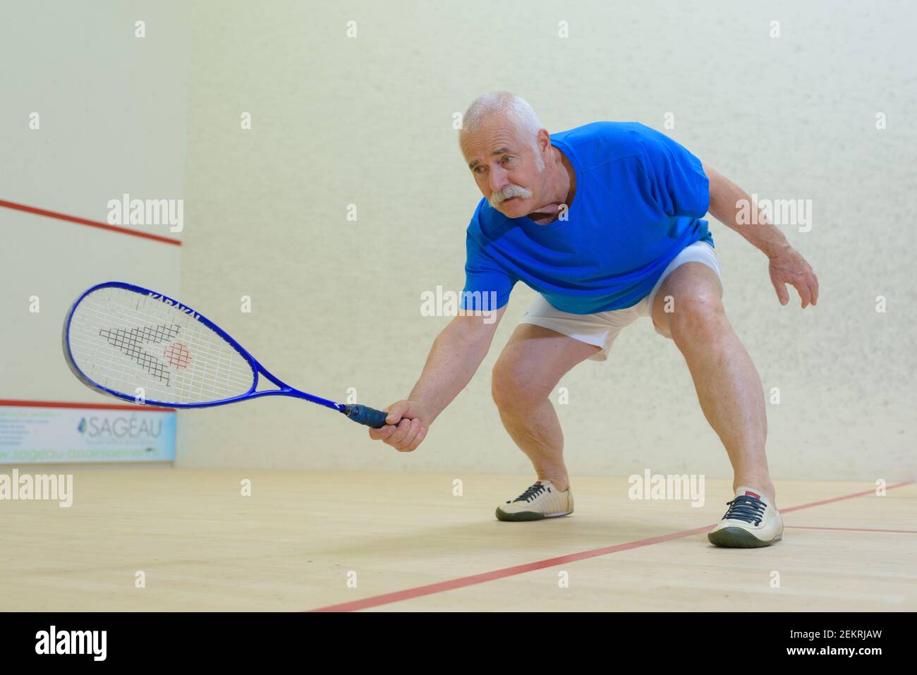 an elderly man playing squash Stock Photo - Alamy