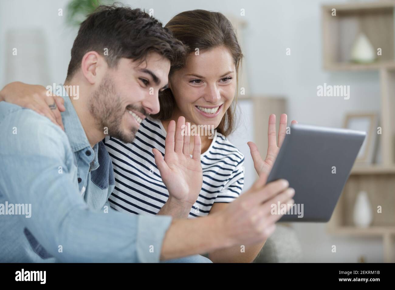 cheerful young couple having a video call Stock Photo - Alamy