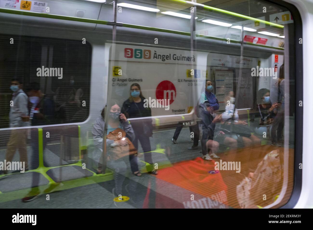 Reflections through the window glass of a subway train car at Angel ...