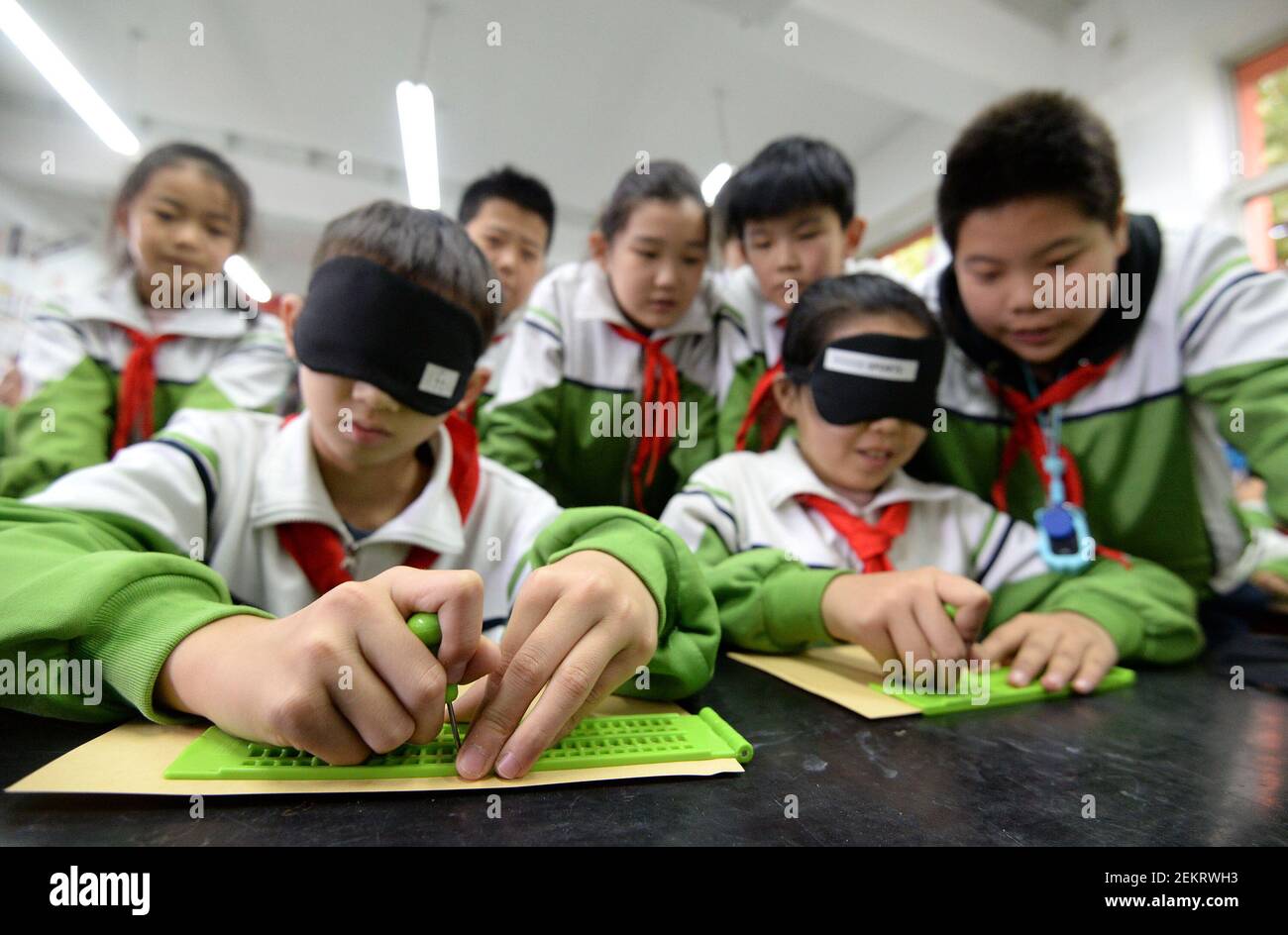 Primary school kids blindfold themselves as part of a blindness ...