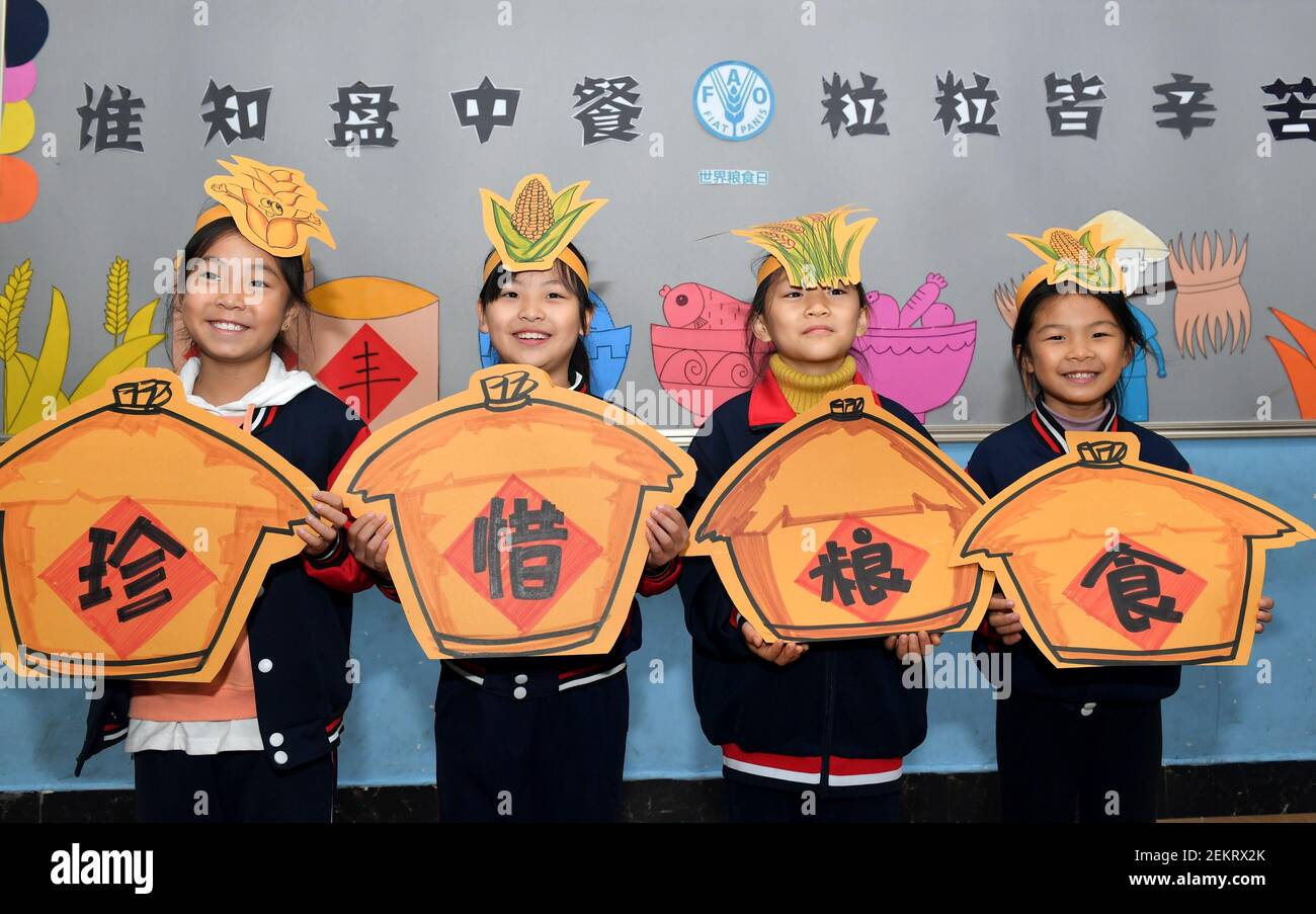 Kids make food-drawing hats in a school to welcome the World Food Day ...