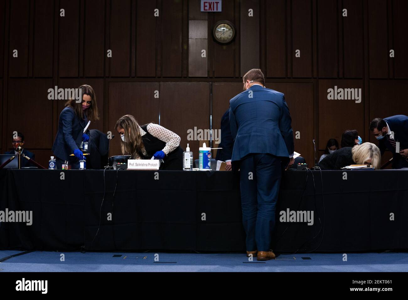 Staffers clean the witness table during the fourth day of the ...