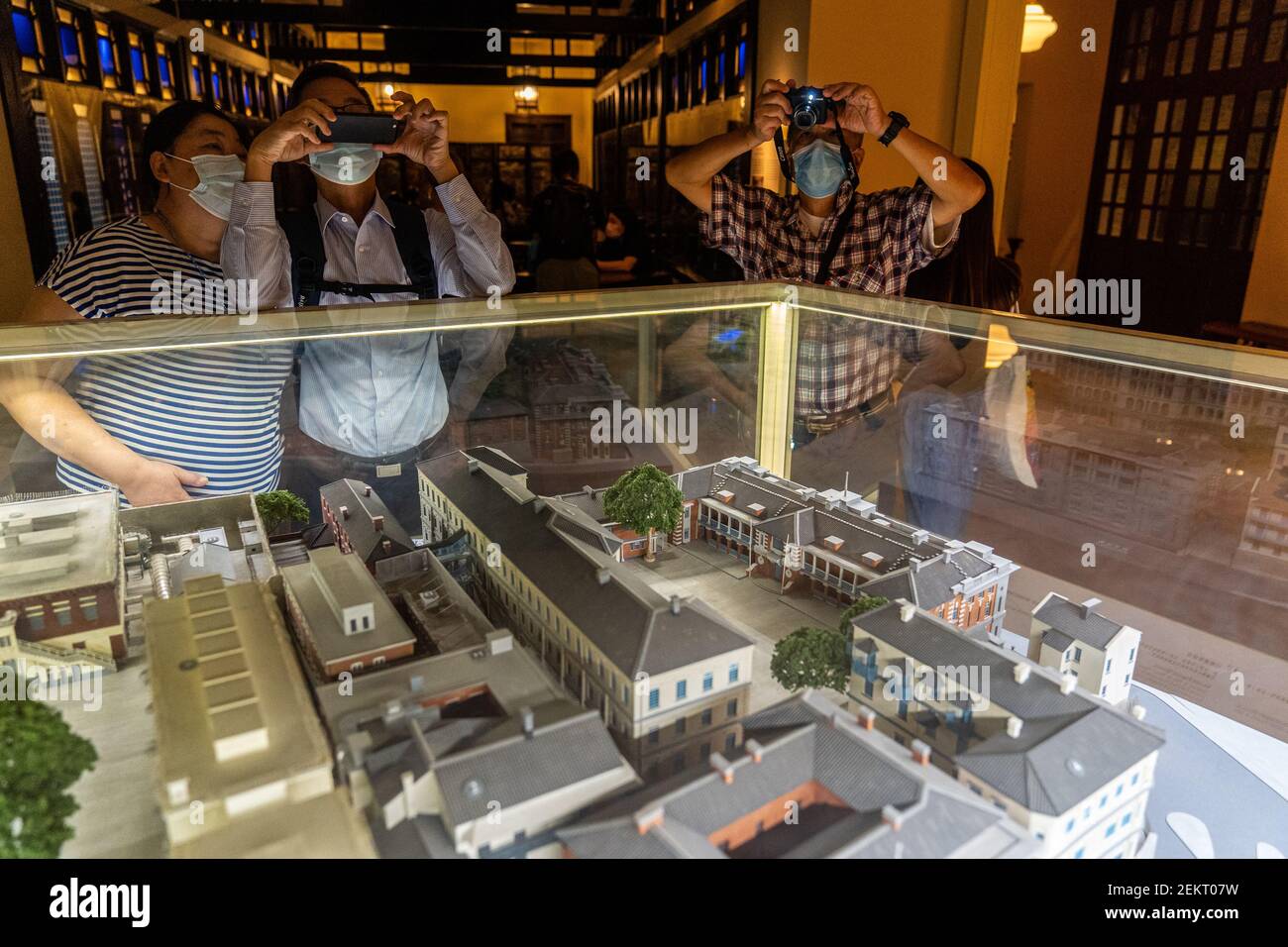 Visitors taking pictures of a replica of neighbourhood at the ...