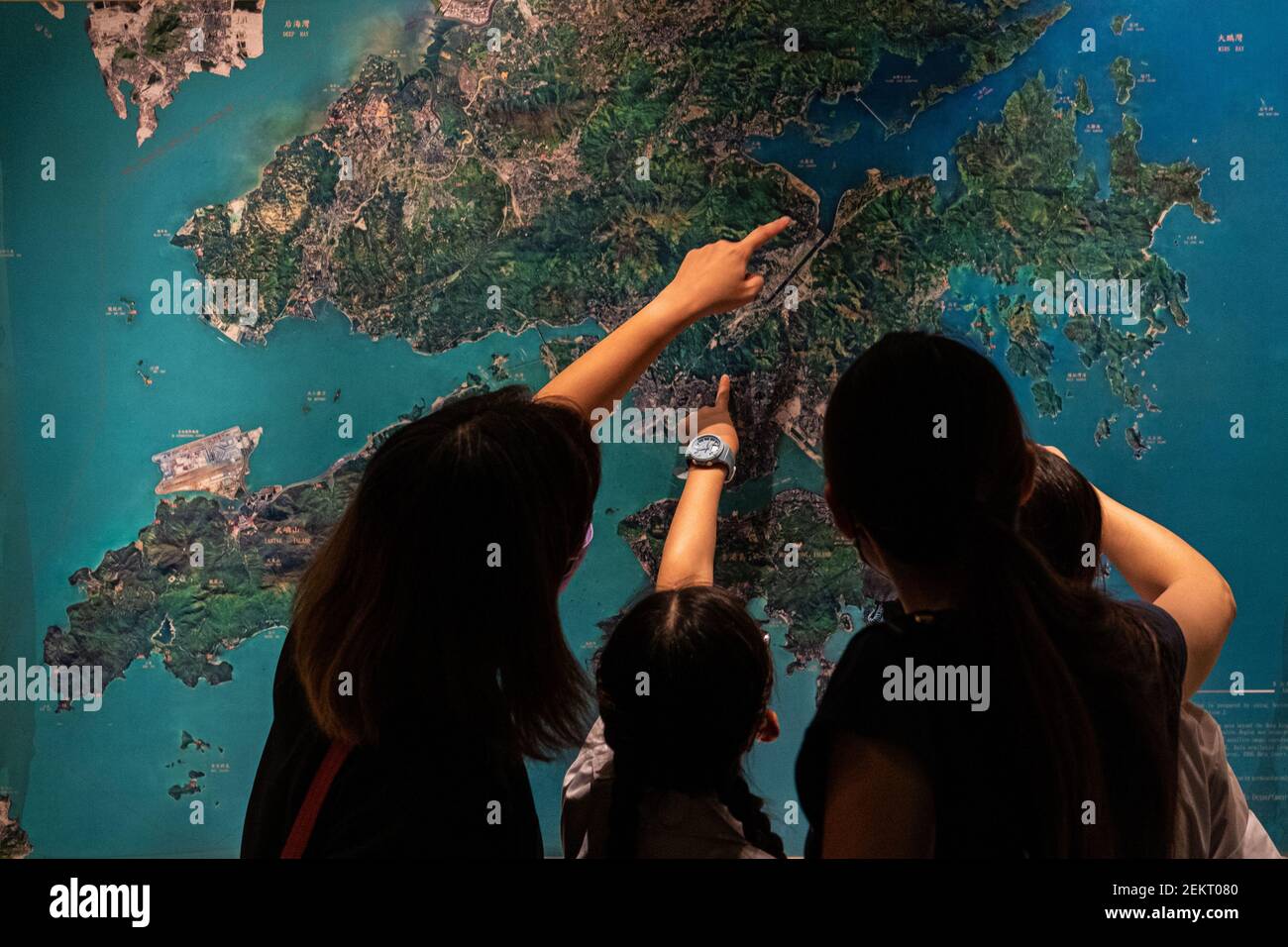 Visitors looking at a map at the exhibition. The â€œHong Kong Storyâ ...