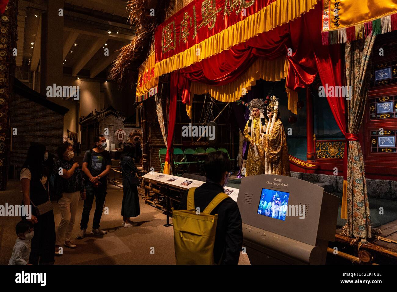 Visitors wearing face masks looking at an ancient exhibit. The â€œHong ...
