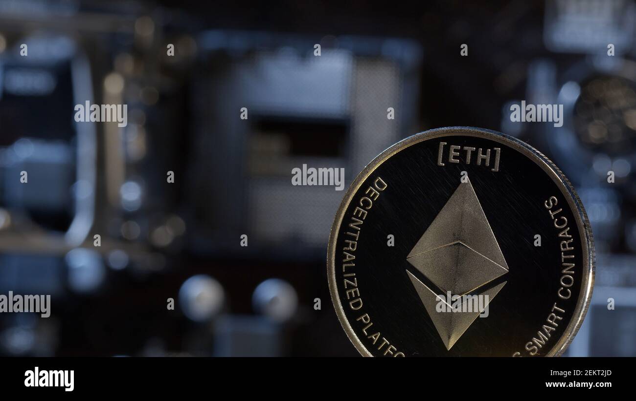 Cryptocurrency mining. Ethereum coin on computer motherboard background ...