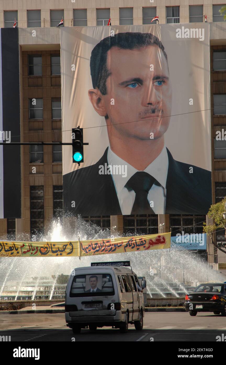 A huge poster of Syrian president Bashar Al Assad hangs from the ...